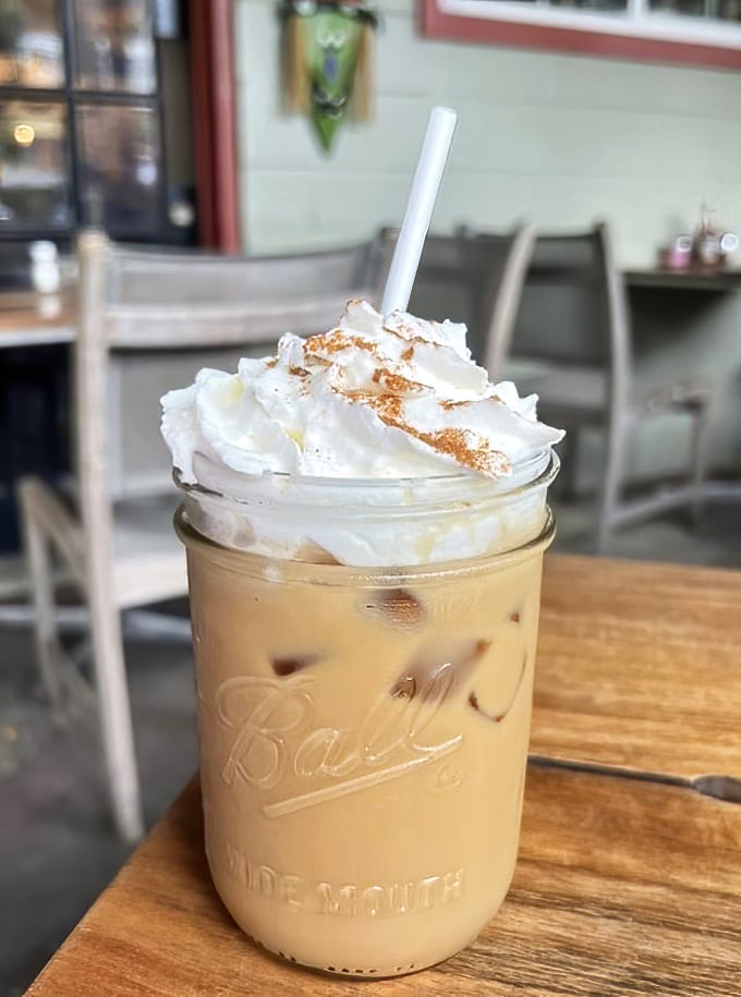 Coffee elevated to art form status—topped with a cloud of whipped cream that makes Monday mornings suddenly seem like a gift rather than a curse.
