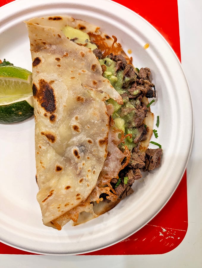 The volcan—where crispy tortilla meets tender meat and creamy guacamole in a textural symphony that makes your taste buds stand and applaud.
