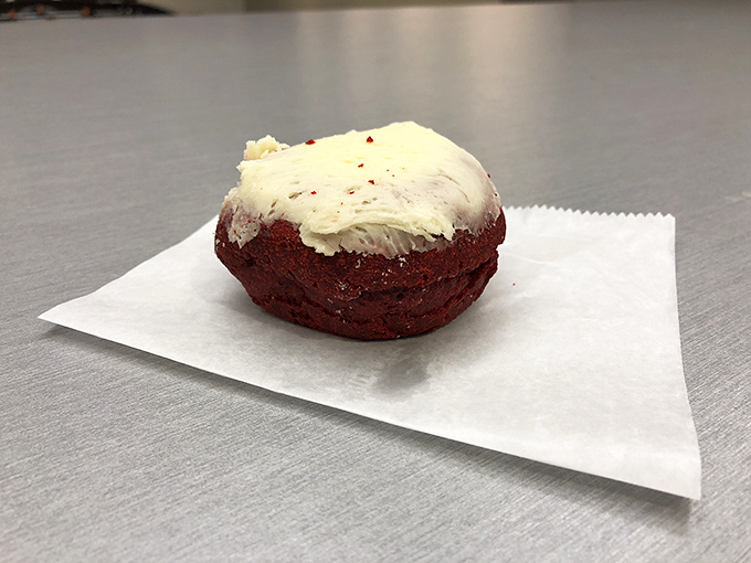 This red velvet donut with cream cheese frosting isn't just dessert—it's formal wear for your taste buds, ready for a black-tie affair.