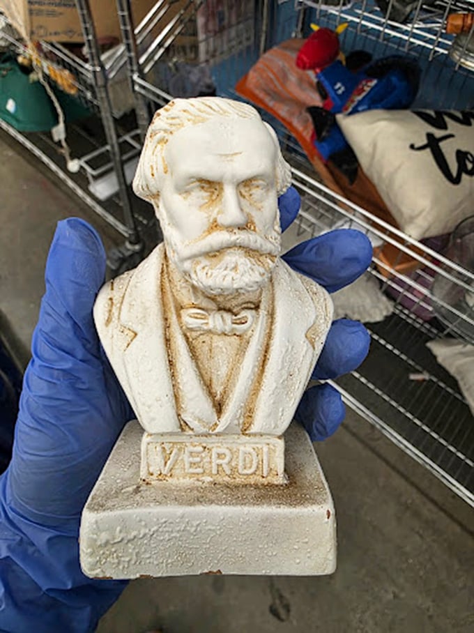 A Verdi bust emerges from the chaos like an operatic surprise. One person's decluttered knickknack becomes another's conversation piece.
