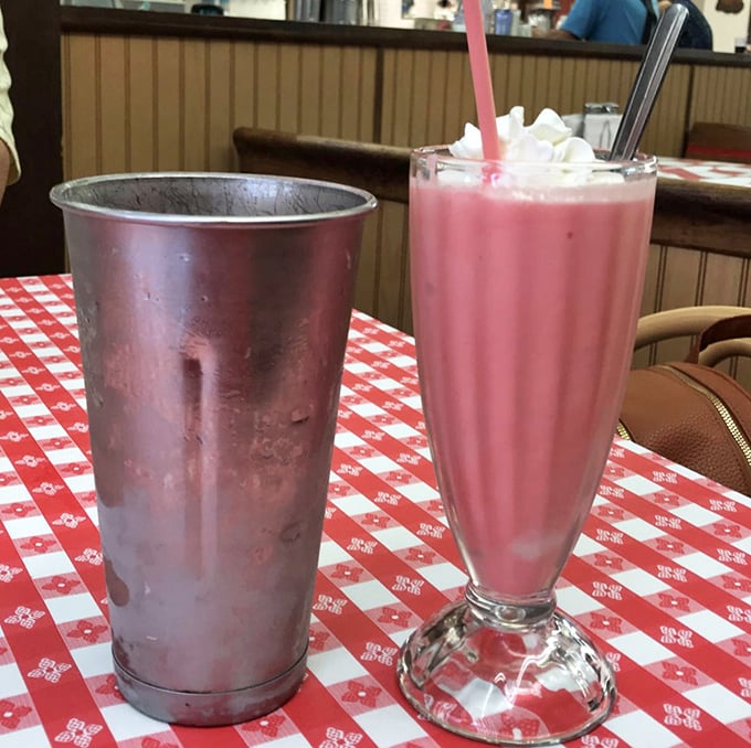 That strawberry shake isn't just pink—it's practically blushing from all the attention. The metal mixing cup is the gift that keeps on giving.