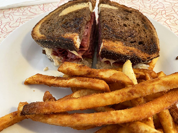 The Reuben sandwich, perfectly grilled and stacked higher than Pennsylvania's Appalachian Mountains, with fries that deserve their own fan club.