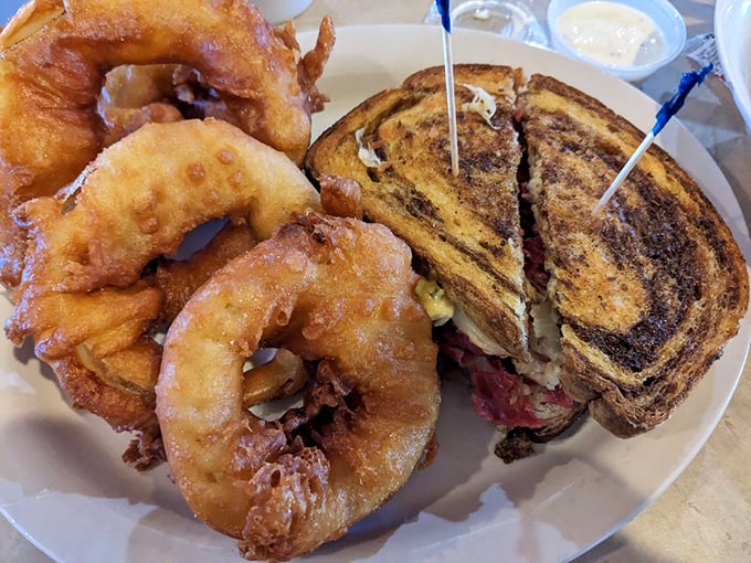 Those onion rings aren't just side dishes—they're golden halos surrounding a sandwich that's earned its place in the comfort food hall of fame.