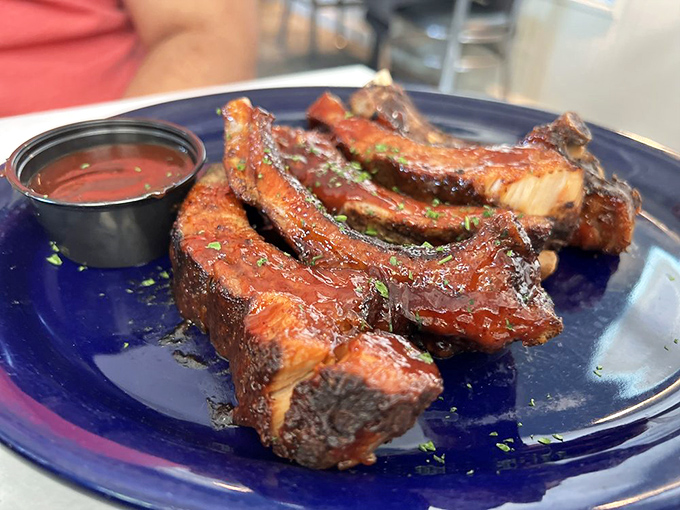 These ribs don't just fall off the bone—they leap willingly into flavor history. The sauce cup is merely a formality at this point.
