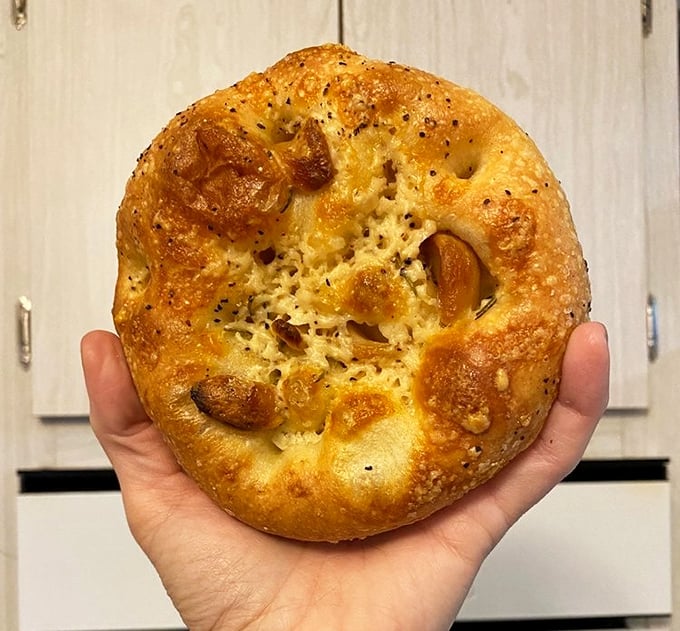 Focaccia that makes Italian grandmothers nod in approval—dimpled, golden, and studded with roasted garlic that announces itself to everyone you talk to afterward.