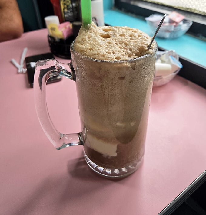 Root beer float in a frosty mug—where childhood nostalgia meets adult-sized portions. The foam alone deserves its own Instagram account.