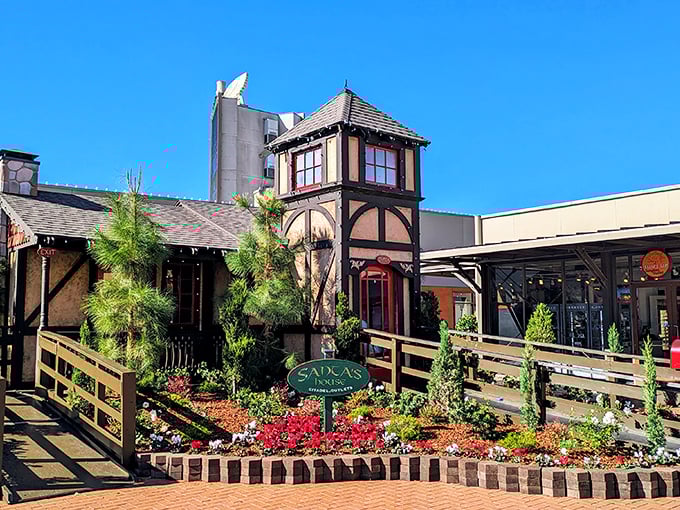 Sadca's House brings a touch of Tudor charm to the outlet experience, surrounded by flowers that seem to say, "Yes, you deserve that fourth shopping bag."