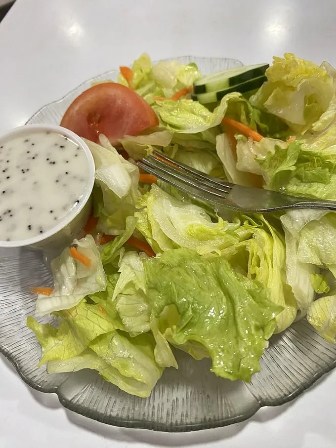 Even the side salad gets the respect it deserves—crisp, fresh, and served in a scalloped glass dish that your grandmother would approve of.