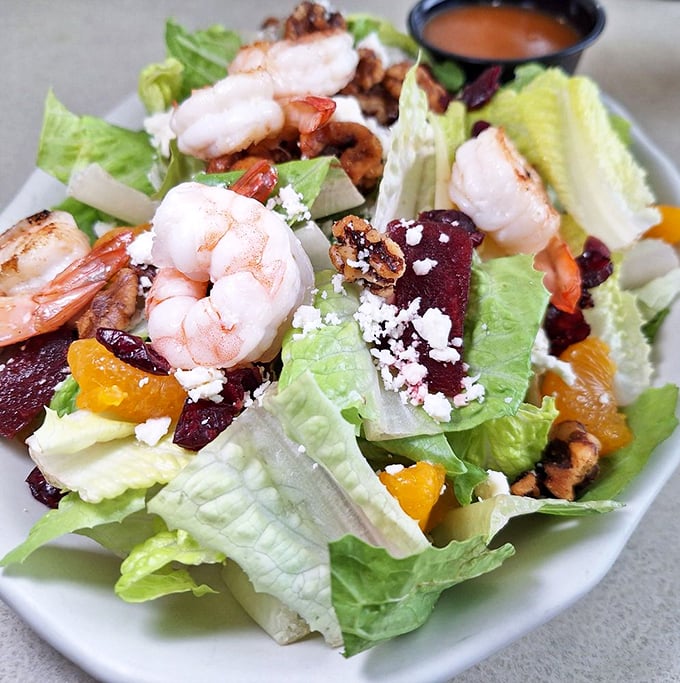 A salad that actually excites – crisp greens playing host to plump shrimp, tangy cheese, and colorful additions that make vegetables feel like the main event.