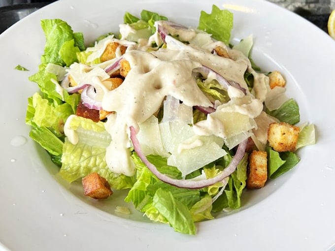 A Caesar salad that knows its role—crisp romaine, just enough dressing, and croutons that crunch. Sometimes the simplest things require the most restraint.