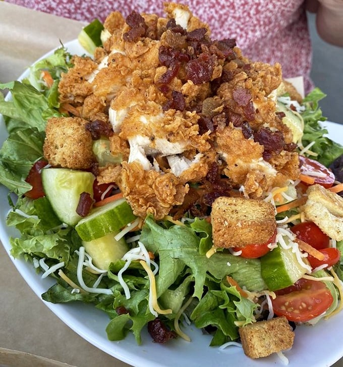 Even their salad gets the royal treatment – crispy chicken perched atop fresh greens with bacon bits playing the role of crunchy confetti.