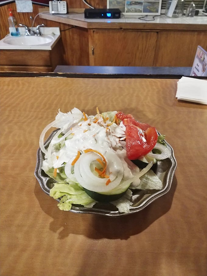 A simple salad that knows its place in the steakhouse hierarchy—fresh, crisp, and ready to provide that token vegetable serving before the main event.