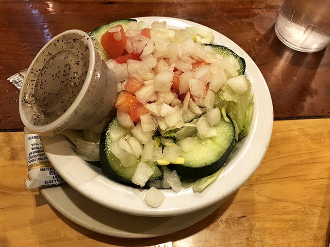 A side salad that actually deserves respect—crisp, fresh, and generous enough to make you momentarily forget about the pie waiting in the wings.
