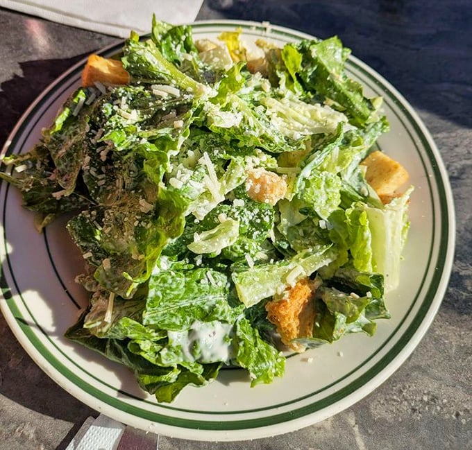A Caesar salad that doesn't apologize for being a salad – crisp, bright, and assertive enough to hold its own on a menu of comfort classics.
