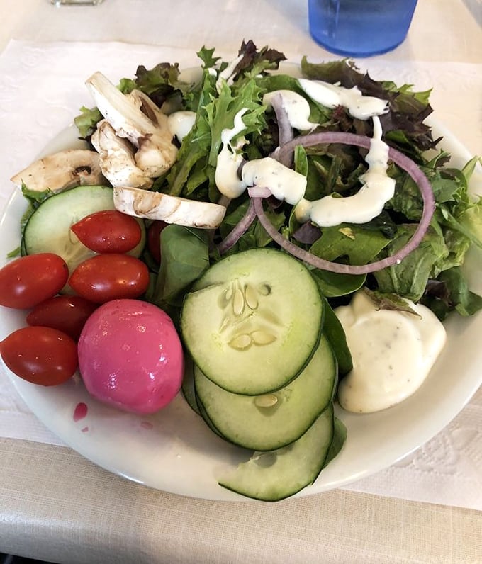 Even the salad looks like it's trying to make amends for being healthy, with those fresh vegetables and creamy dressing.