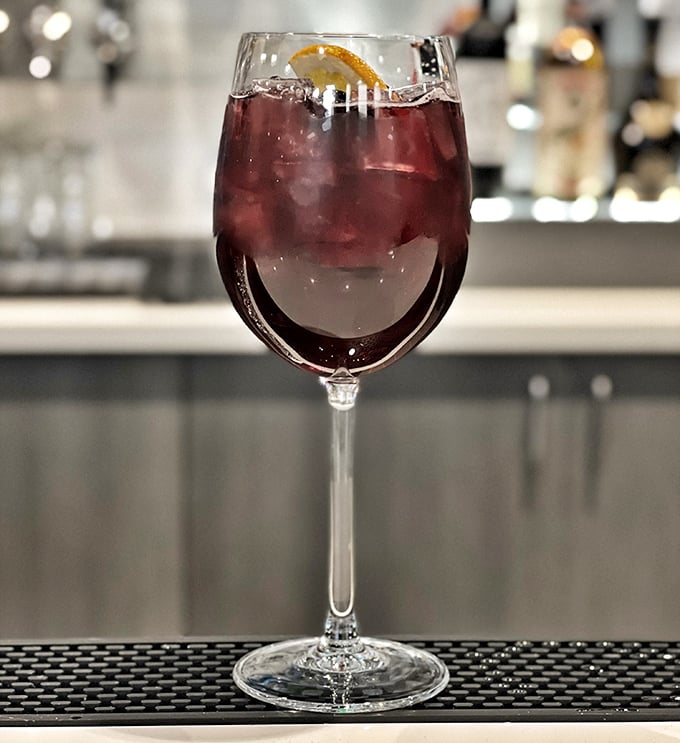 A sangria that's dressed better than most people at dinner. That citrus garnish isn't just pretty – it's plotting to make your evening memorable.