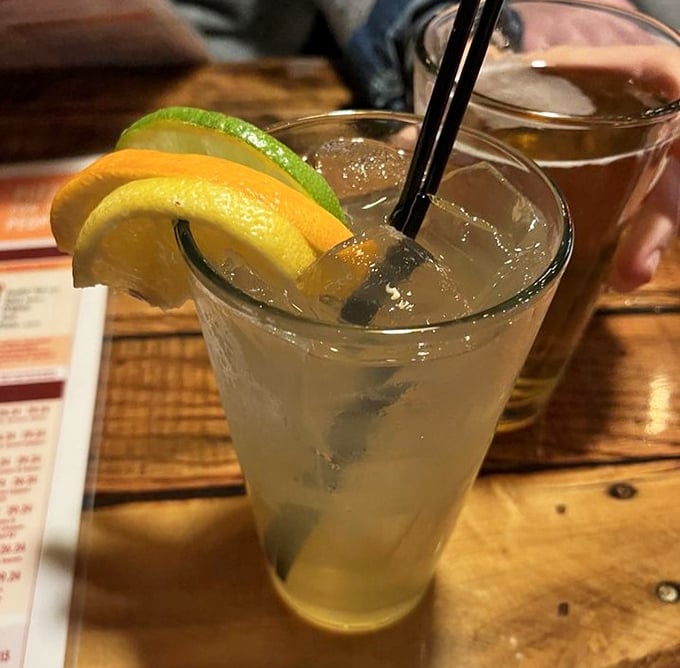A refreshing cocktail garnished with citrus slices – because sometimes you need something bright and zippy to cut through all that glorious cheese.