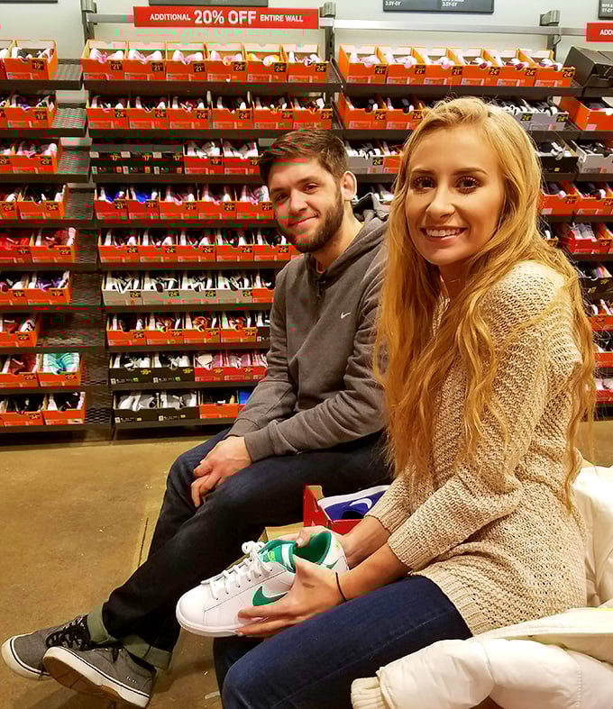 Happy shoppers showing off their Nike finds. That look of satisfaction comes from knowing they just scored sneakers at a fraction of retail price.