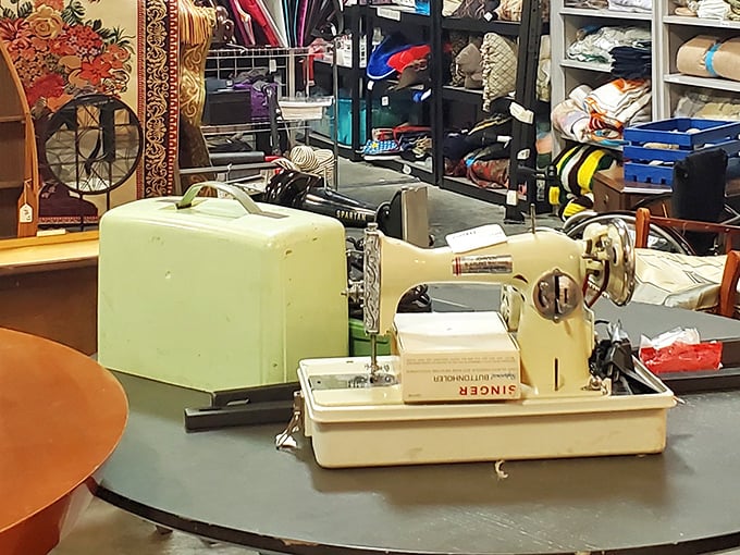 A vintage Singer sewing machine stands ready for its second act—like finding Audrey Hepburn's autograph at a yard sale.