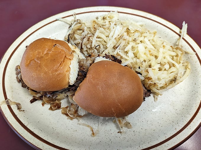 Two humble sliders with a side of hash browns—proof that sometimes the simplest combinations create the most profound satisfaction.