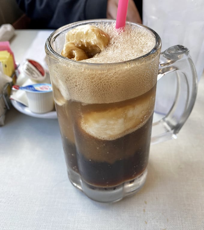 This root beer float isn't just a drink—it's a frothy tower of childhood memories topped with ice cream that's making a grand entrance.