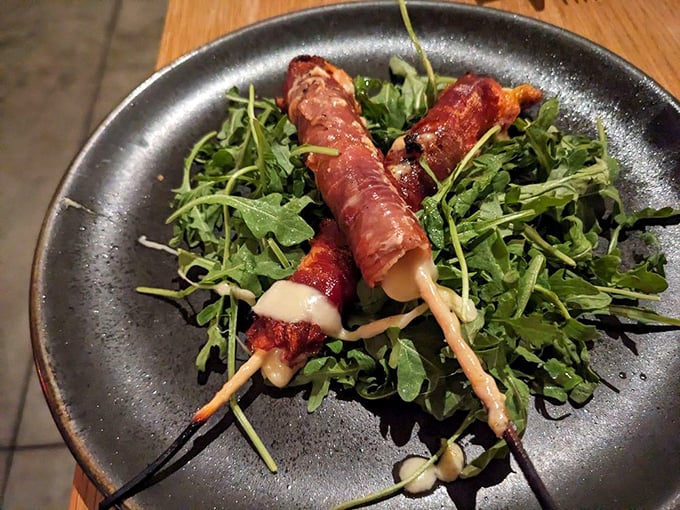Spiedini—Italian for "why have we been eating cheese sticks wrong our entire lives?" Prosciutto-wrapped fontina on a bed of peppery arugula.