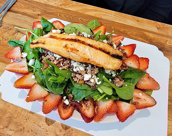 Who knew healthy could look this tempting? Grilled salmon perched atop spinach and strawberries—a California dream that tastes as good as it looks.