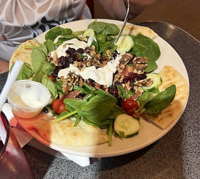 A garden on a plate—this spinach salad proves diners can do fresh and vibrant alongside their comfort food classics.