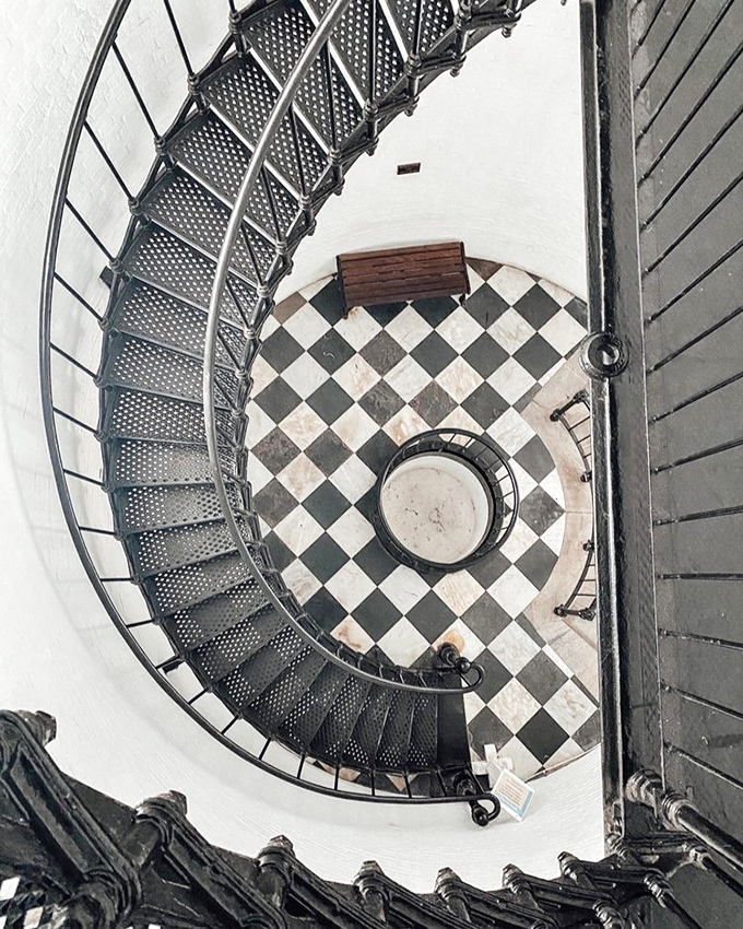 The lighthouse's spiral staircase is a dizzying work of art—219 steps of iron lace that would make M.C. Escher reach for his sketchpad.