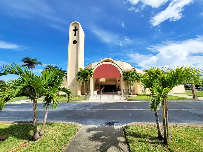 St. Sebastian Catholic Church reaches skyward with architectural flair, its distinctive tower standing like a spiritual lighthouse amid a sea of palm trees.