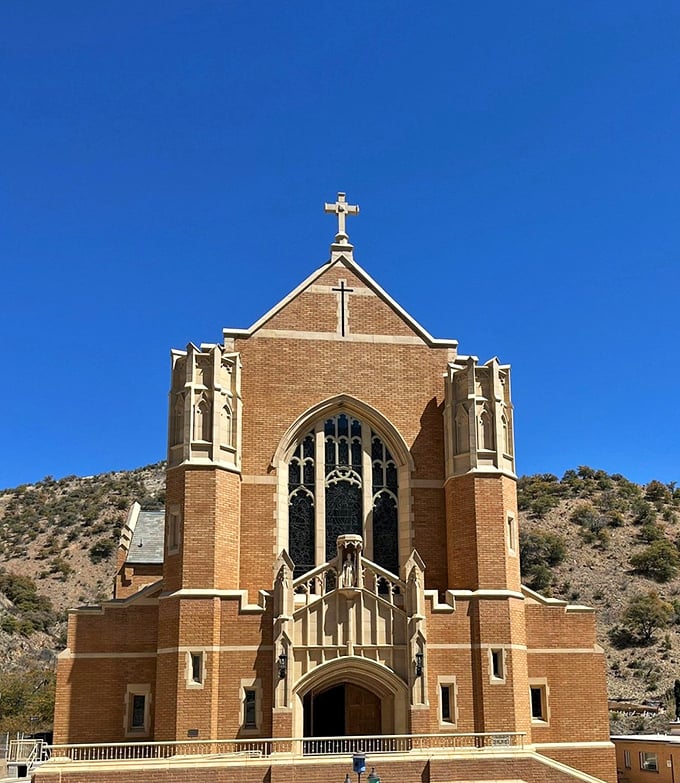 St. Patrick Catholic Church stands majestically against Bisbee's desert hills. Its brick facade and Gothic windows speak to the town's prosperity during mining days.
