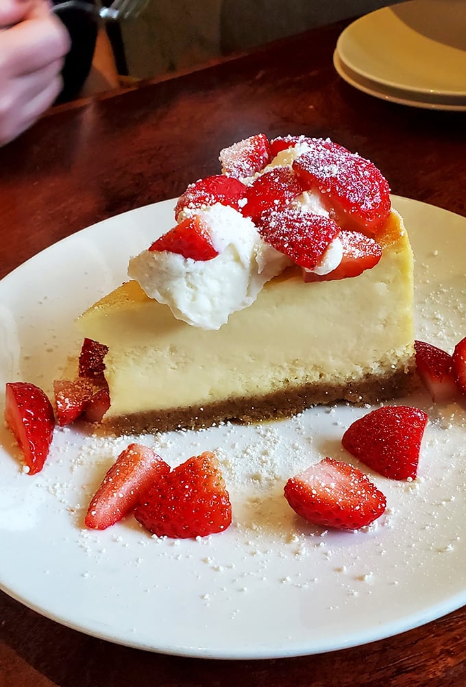 Strawberry cheesecake that looks like it belongs in a magazine spread – dessert photography at its most tempting peak.