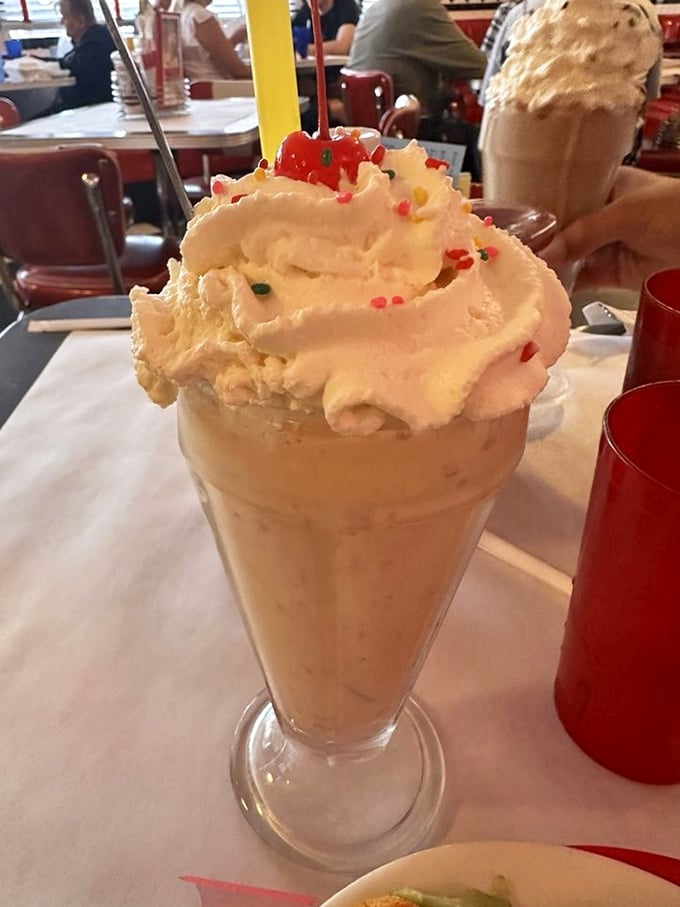This isn't just a milkshake—it's architecture with a straw, topped with enough whipped cream to make your dentist weep and your Instagram followers swoon.