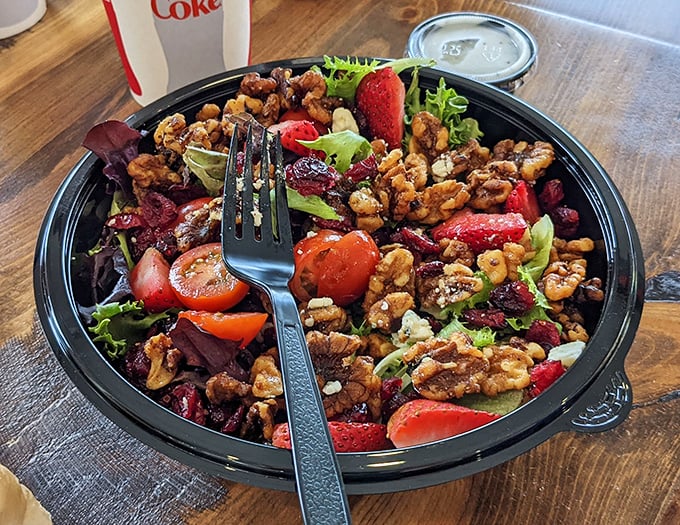 A salad that doesn't apologize for being healthy – crisp greens, juicy strawberries, and candied walnuts creating the perfect counterpoint to all that fried goodness.
