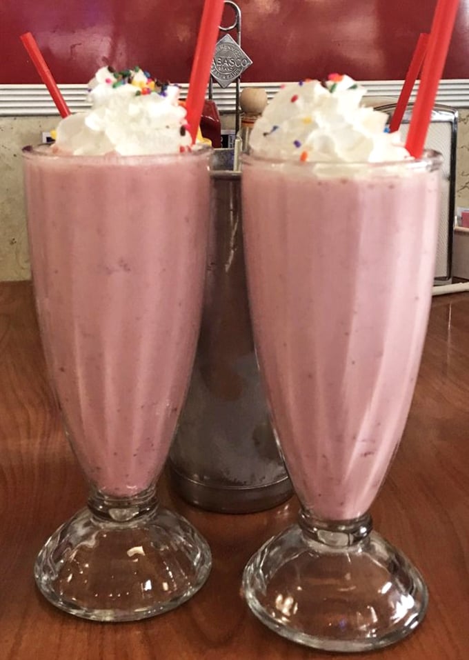 Twin strawberry shakes topped with whipped cream – proof that sometimes the best things in life come in pairs.