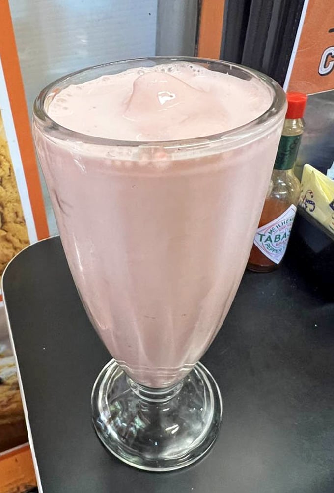 This strawberry milkshake isn't just a drink—it's architecture. The glass is merely containing what could easily be classified as dessert infrastructure.