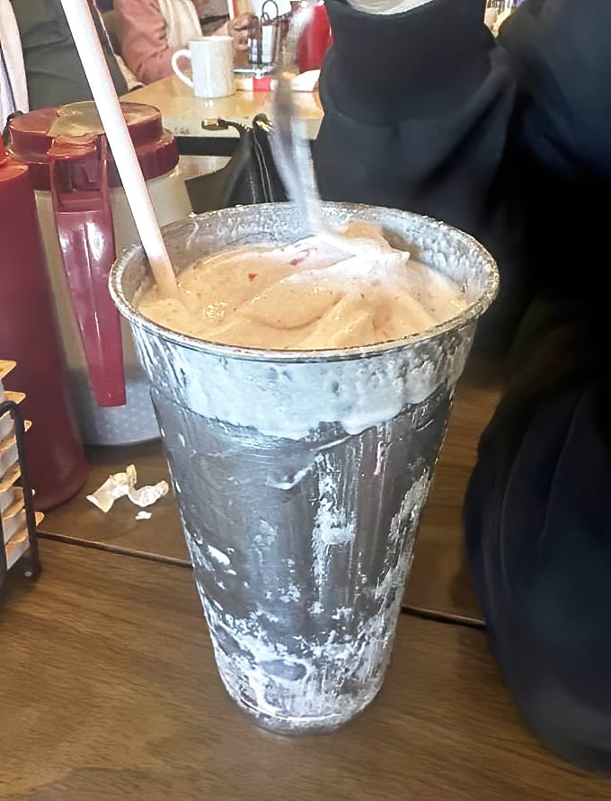 The classic metal shake cup—cold enough to form condensation beads that race down the sides like Olympic skiers on fresh powder.