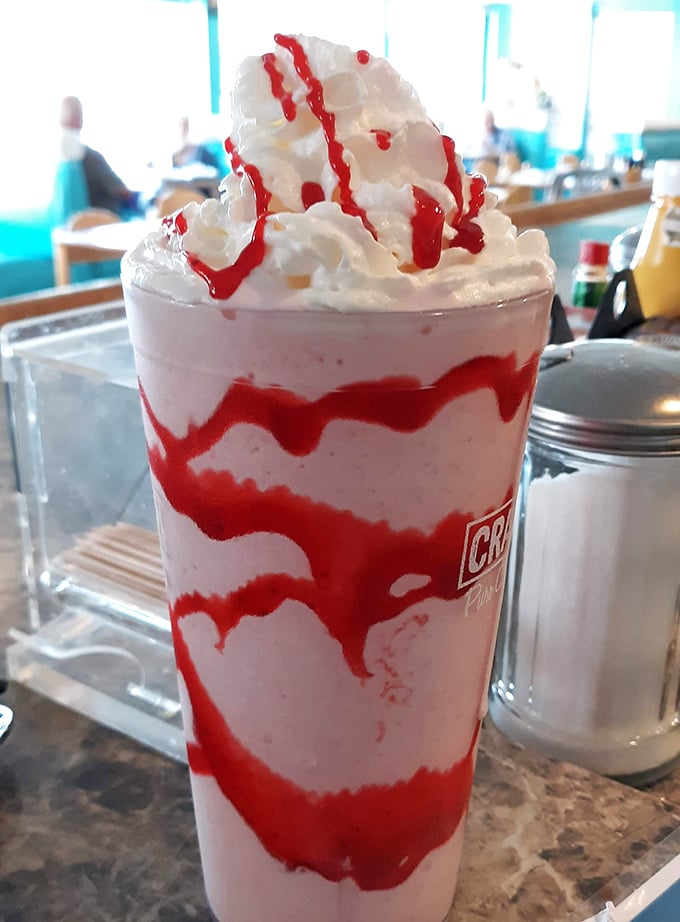 This strawberry milkshake isn't just a drink—it's a striped masterpiece that makes you wonder why museums don't have dessert exhibits.