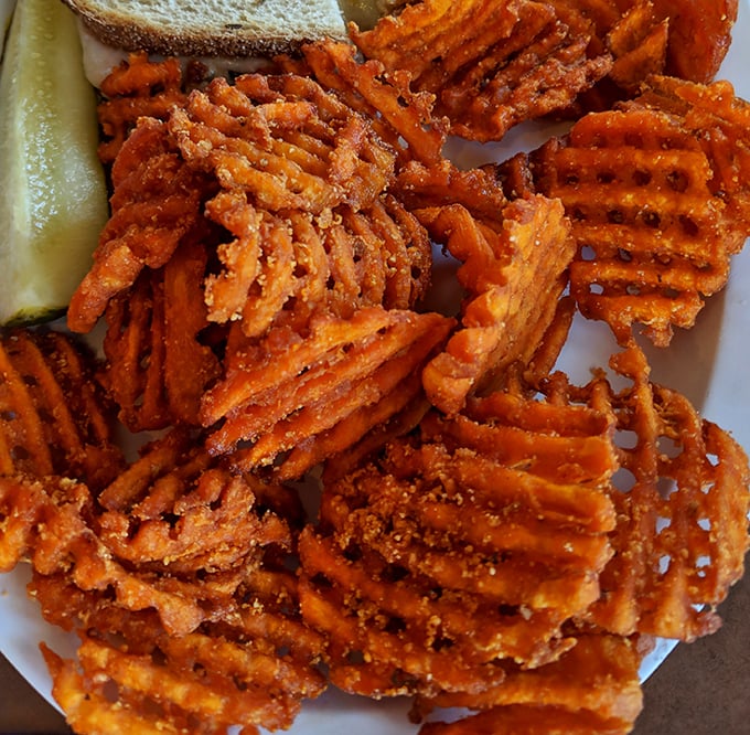Sweet potato waffle fries that make regular fries question their life choices – crispy, seasoned, and impossible to stop eating once you start.
