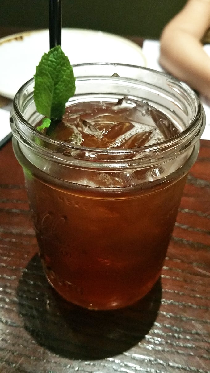 Sweet tea served in a mason jar with fresh mint – because sometimes the simplest pleasures are the most satisfying. Pure Southern comfort in liquid form.