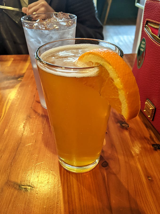 A craft beer with an orange slice – because sometimes your palate needs a refreshing intermission between acts of meat consumption.
