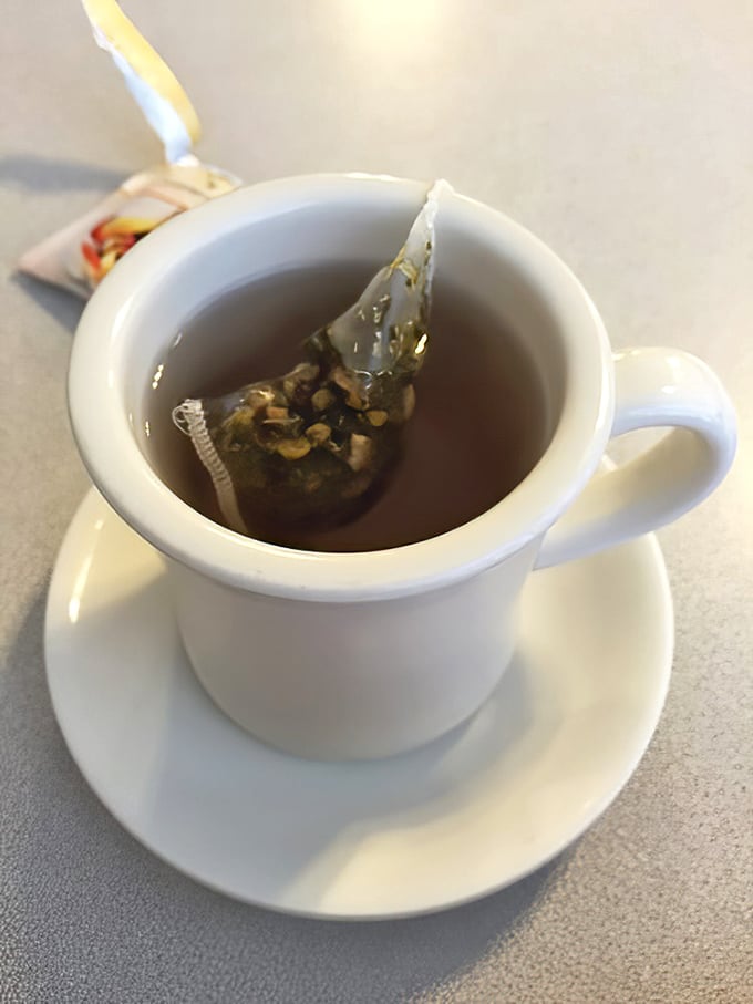 A proper cup of hot tea served in a sturdy white mug—civilization's most underrated morning ritual.