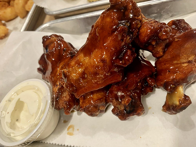 These glazed wings aren't just sticky and sweet—they're the reason napkins were invented. That dipping sauce is calling your name.