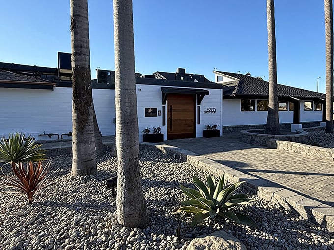 Modern minimalism meets desert landscaping at this Goleta property, where palm trees stand like exclamation points against the pristine white walls.