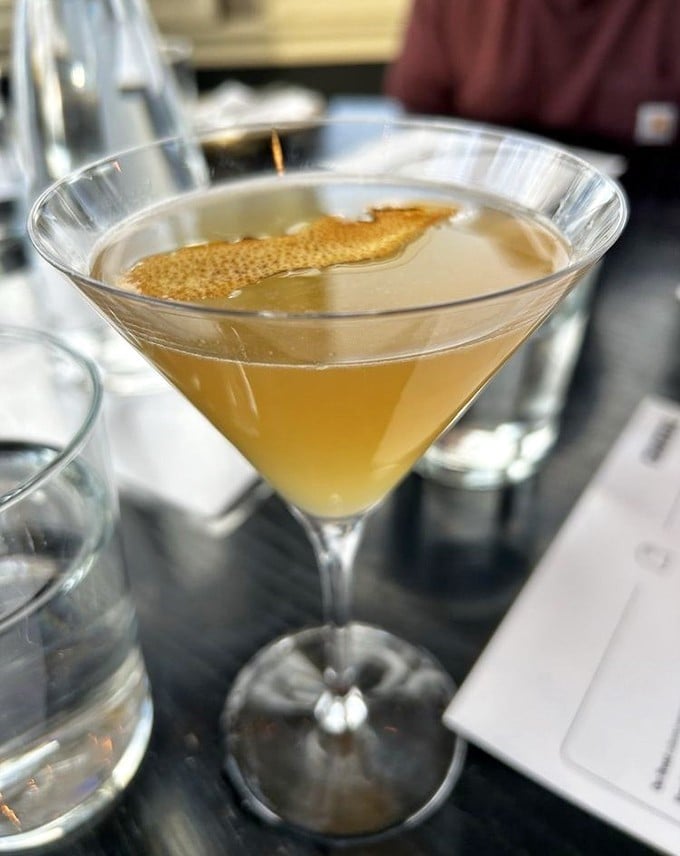 A cocktail so elegant it makes you sit up straighter. That floating citrus peel isn't just garnish—it's aromatherapy for your taste buds.