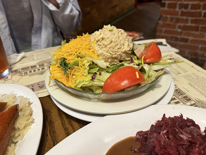A garden of fresh vegetables surrounding potato salad like a moat around a delicious castle. German food isn't all meat—sometimes there's cheese on the vegetables!