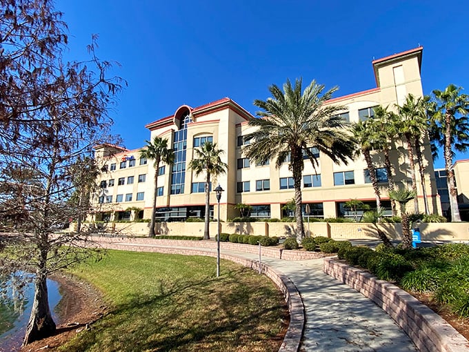 UF Health Leesburg Hospital's modern campus nestled alongside water reminds us that healing environments matter—palm trees included at no extra charge.