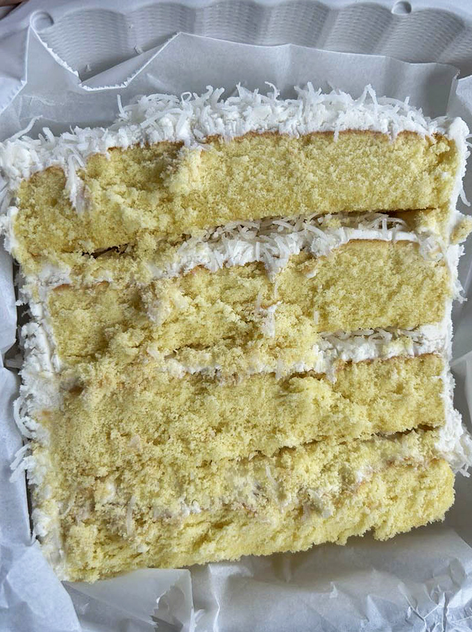 Coconut cake that looks like it belongs in a bakery window on a New York street corner—layer upon glorious layer.