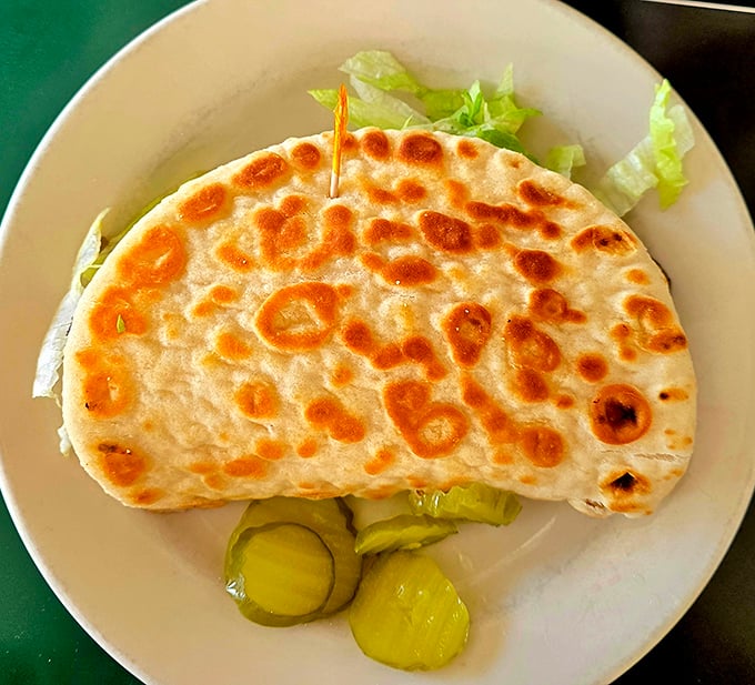 Even the veggie options shine—this grilled pita with fresh vegetables and pickles proves that meatless doesn't mean flavorless in this culinary time capsule.