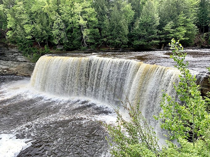 The root beer-colored cascade creates nature's ultimate infinity pool, where the boundary between river and sky blurs into misty perfection.